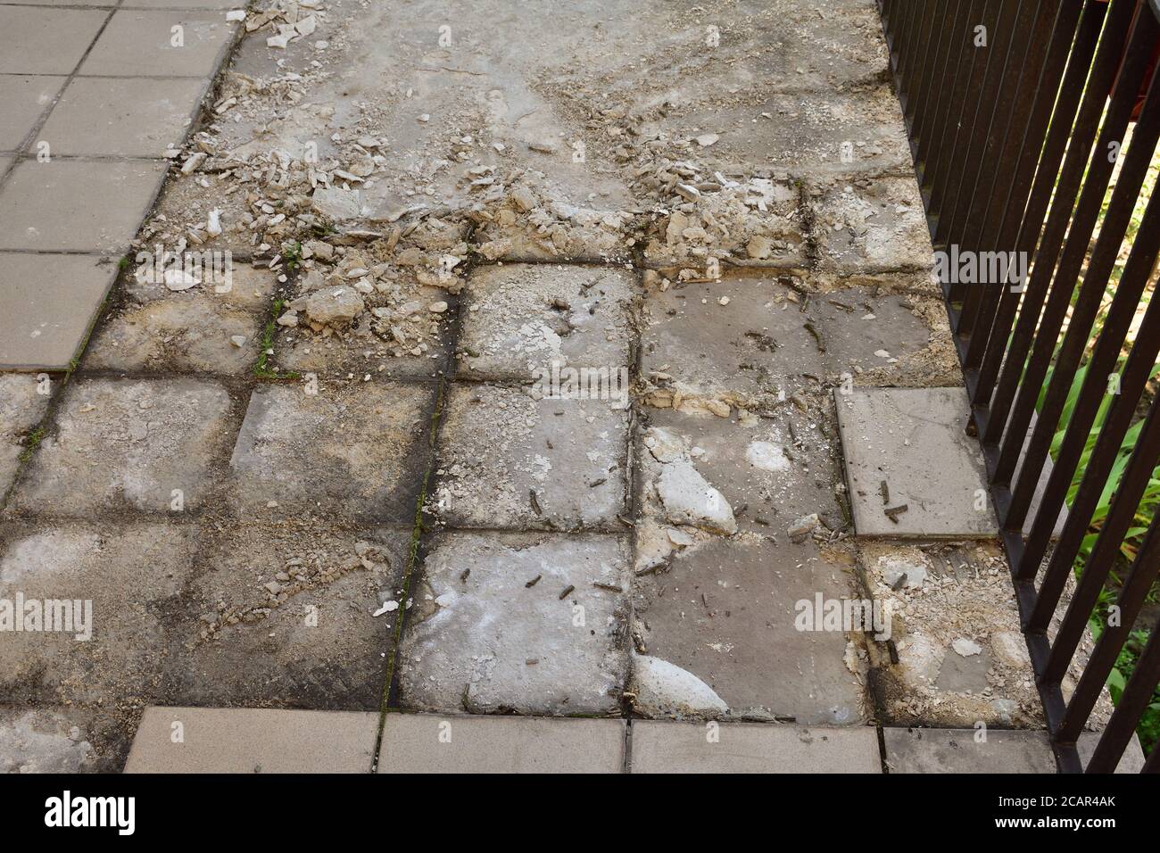 Chipping off old tiles on the terrace during renovation, replacing them ...
