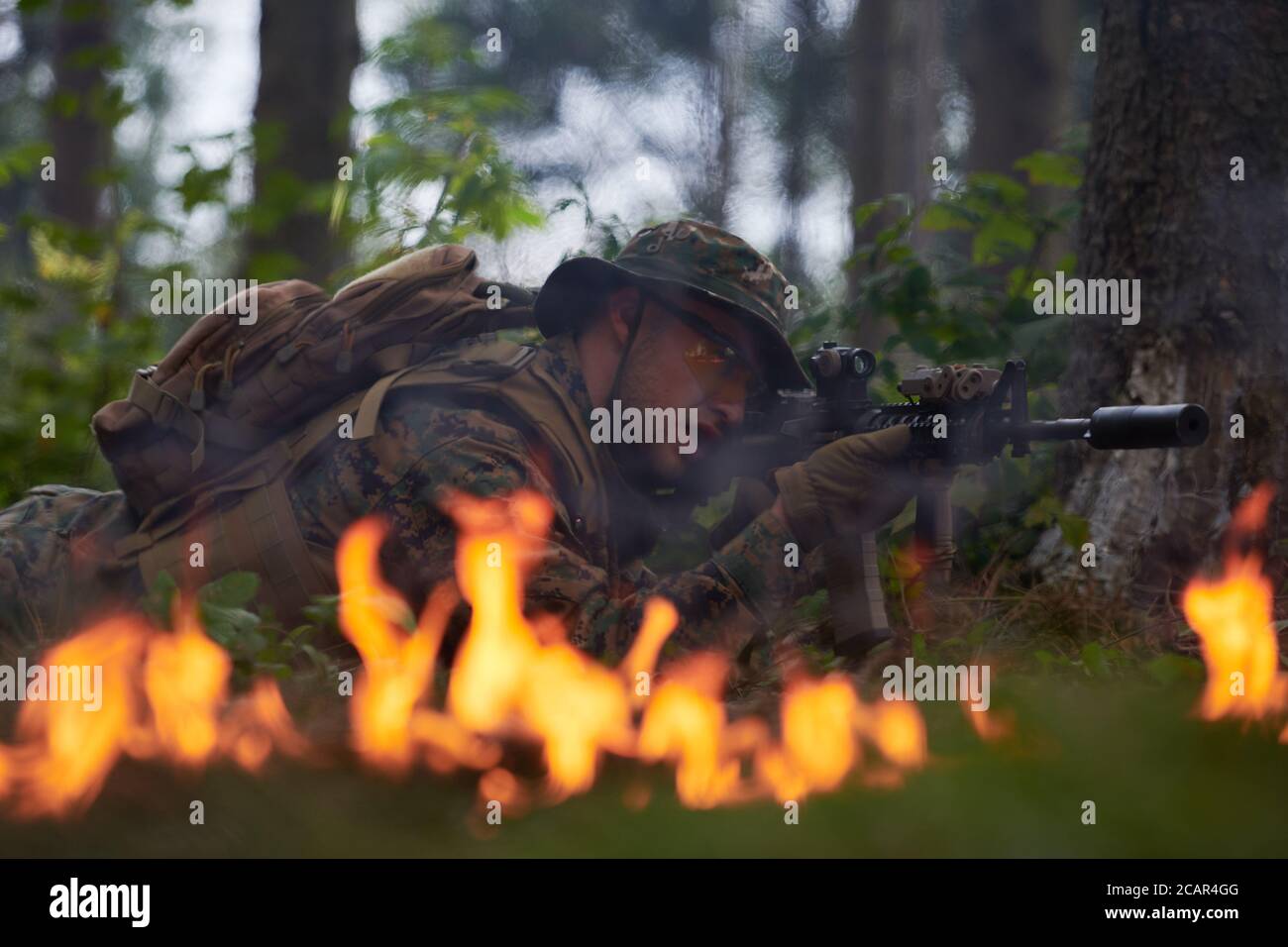 modern warfare soldier in action aiming at weapon laser sight optics in ...
