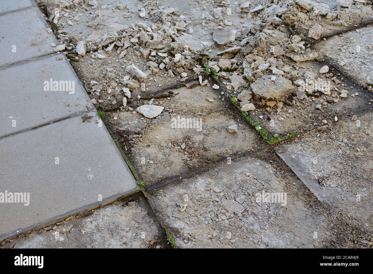 Chipping off old tiles on the terrace during renovation, replacing them ...