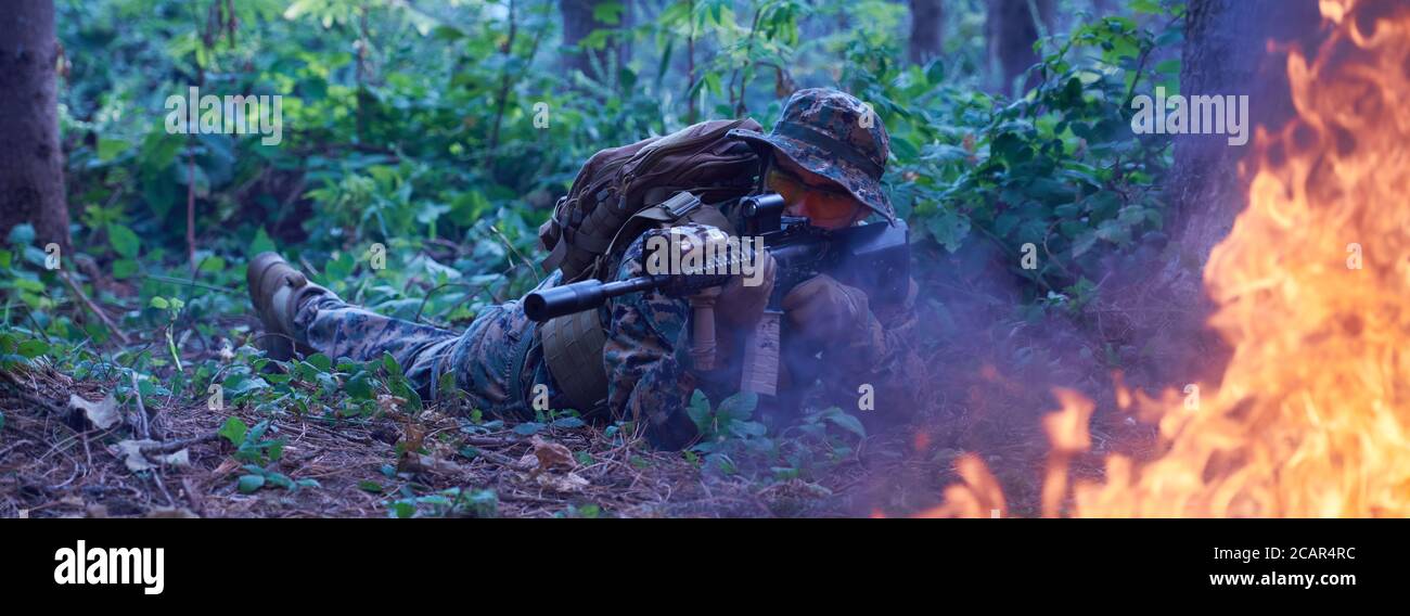 modern warfare soldier in action aiming at weapon laser sight optics in ...