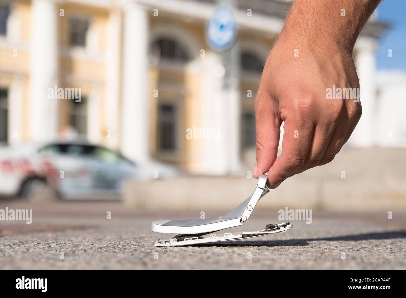 Male hands holding broken mobile smartphone after drop, view from above ...