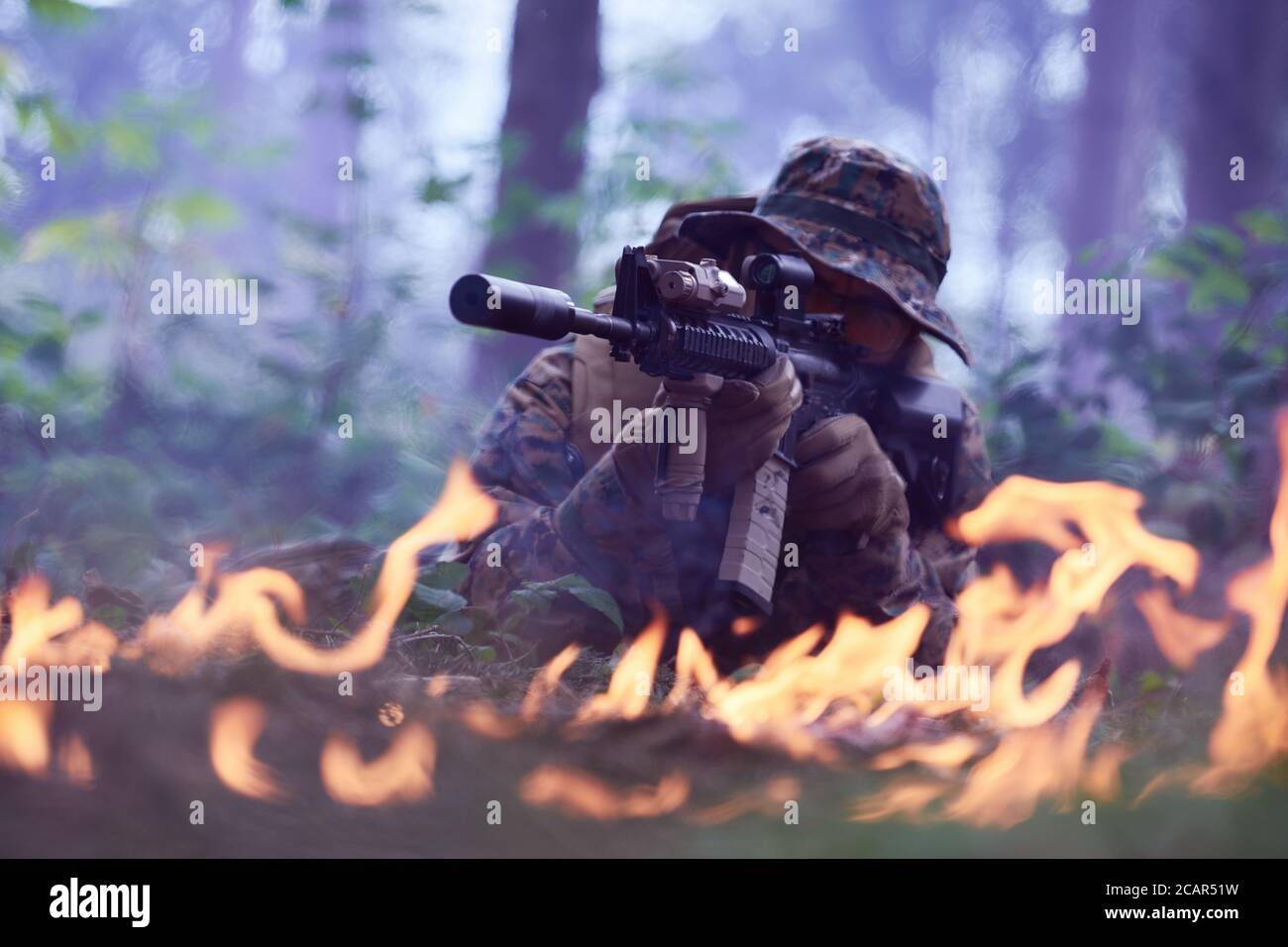 modern warfare soldier in action aiming at weapon laser sight optics in ...