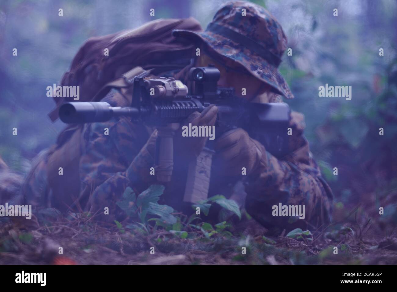 modern warfare soldier in action aiming at weapon laser sight optics in ...
