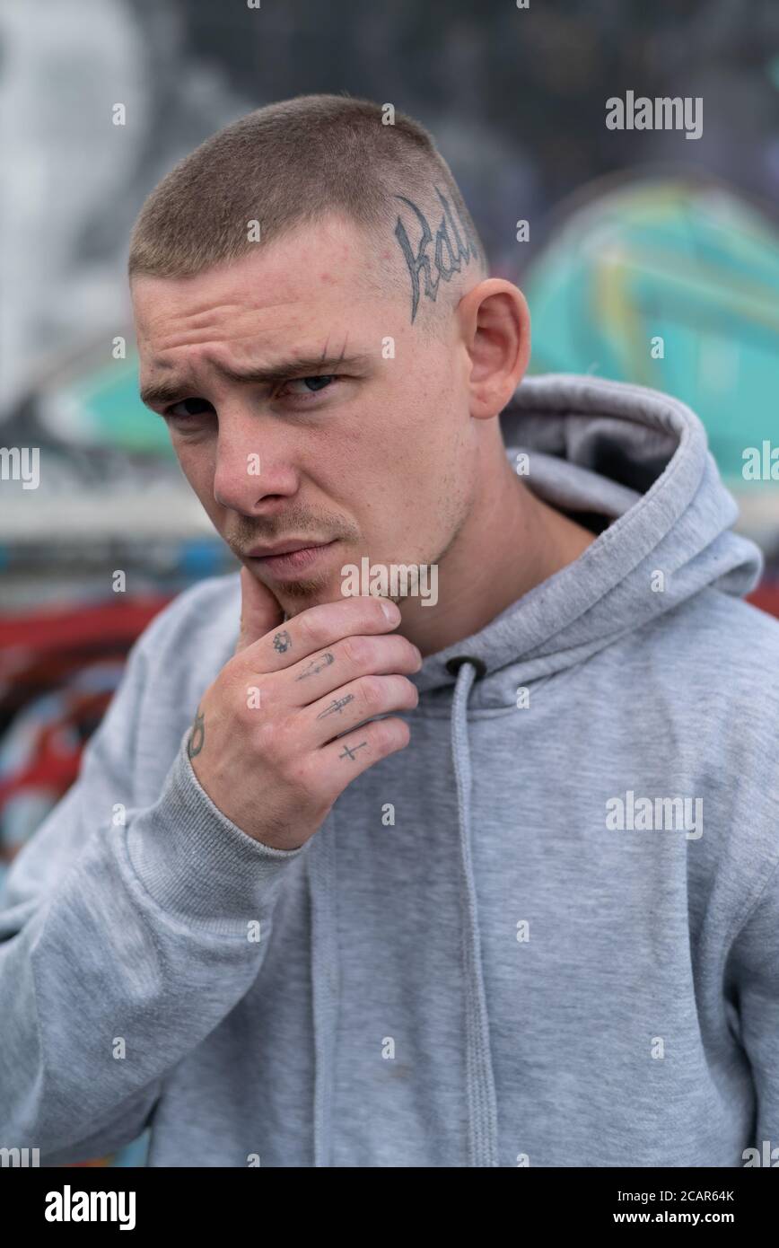 A bully guy in a light sports jacket with a hood Stock Photo - Alamy