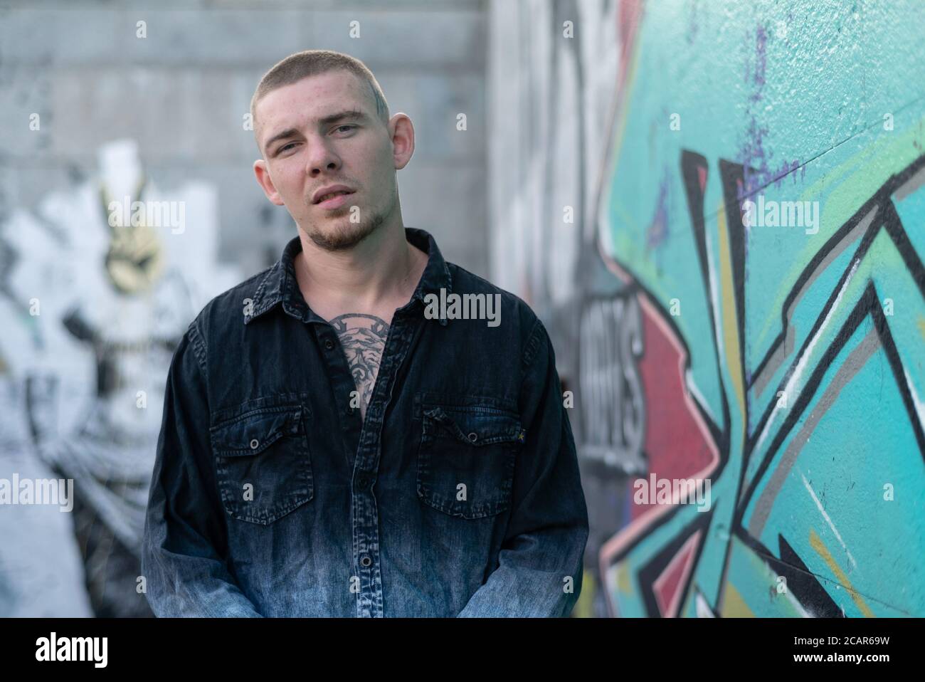 Young guy bully in black shirt Stock Photo - Alamy