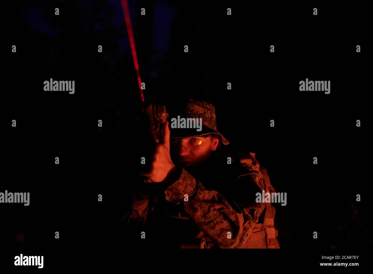 soldiers squad in action on night mission using laser sight beam lights ...