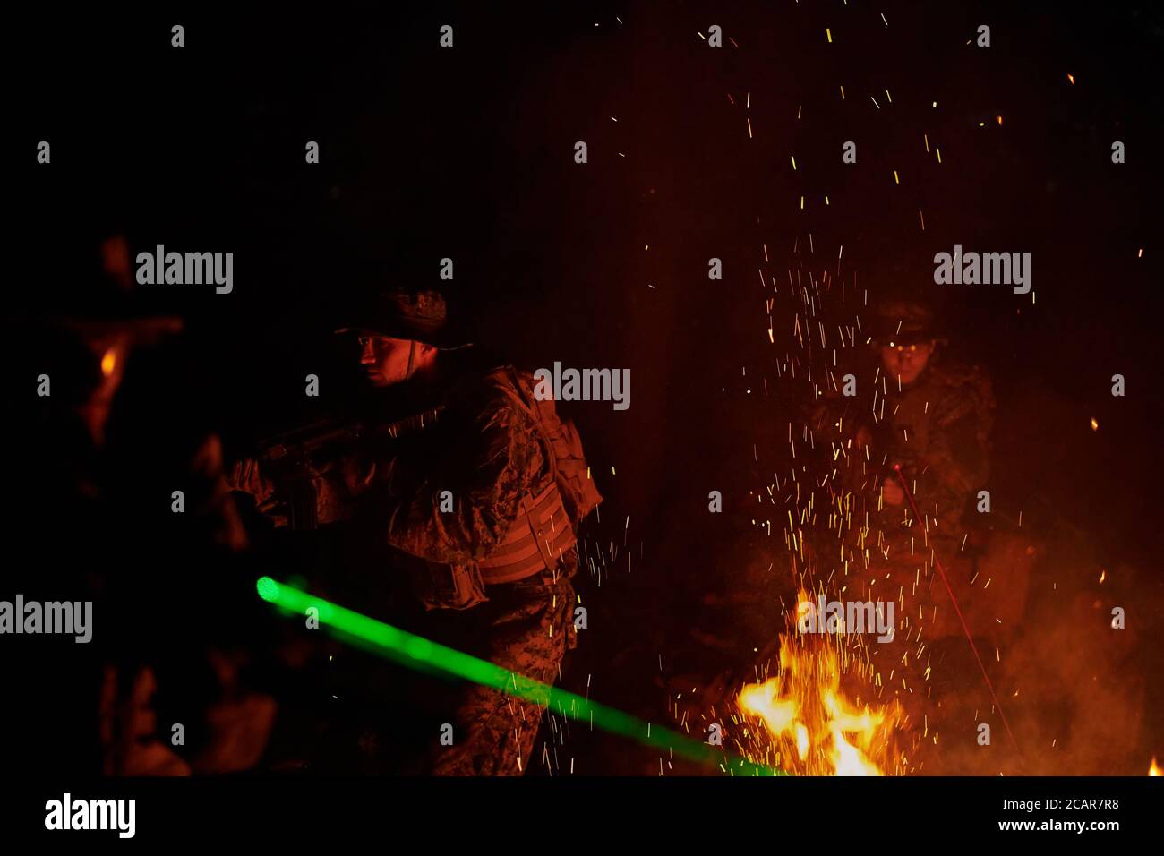 soldiers squad in action on night mission using laser sight beam lights ...