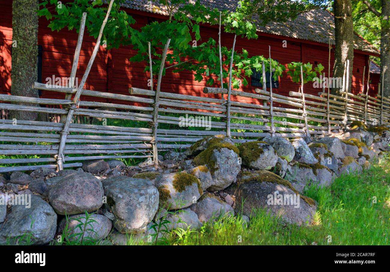 traditional fence made by stones and timbers at an old farm in Sweden ...