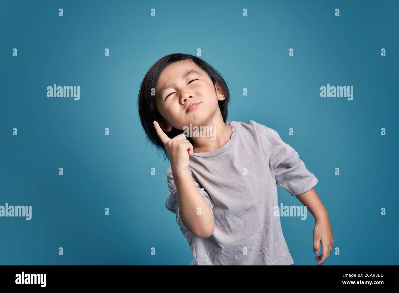 Beautiful asian little kid show wonder, imagine, think, or hesitate ...