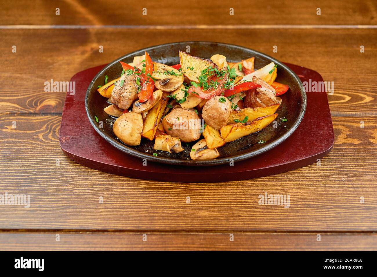 A plate of food sitting on top of a wooden table Stock Photo - Alamy