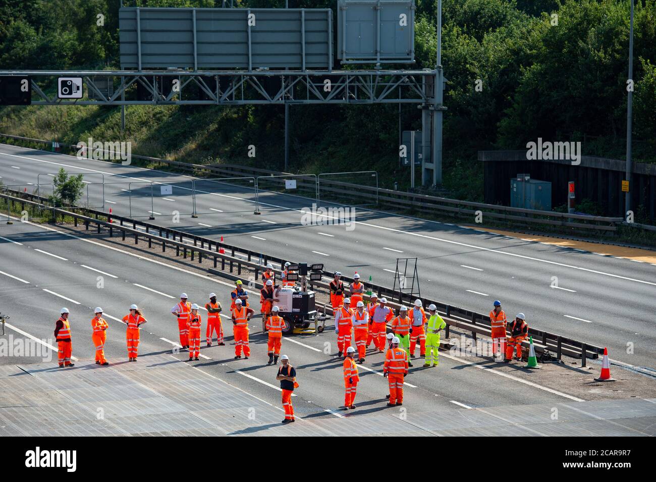 HS2 workers watch as a bridge is wheeled into position over the M42 at ...