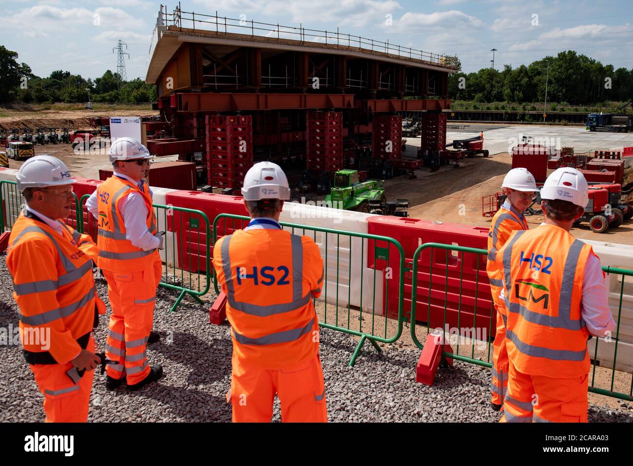 HS2 workers watch as a bridge is wheeled into position over the M42 at ...