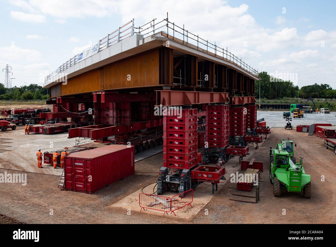 HS2 workers watch as a bridge is wheeled into position over the M42 at ...