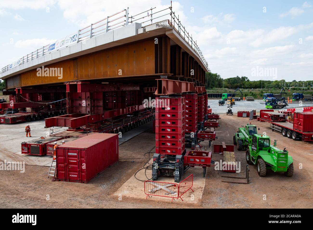 HS2 workers watch as a bridge is wheeled into position over the M42 at ...