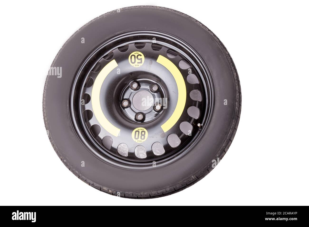 Full size black car spare tire with yellow marking and signs on a white ...