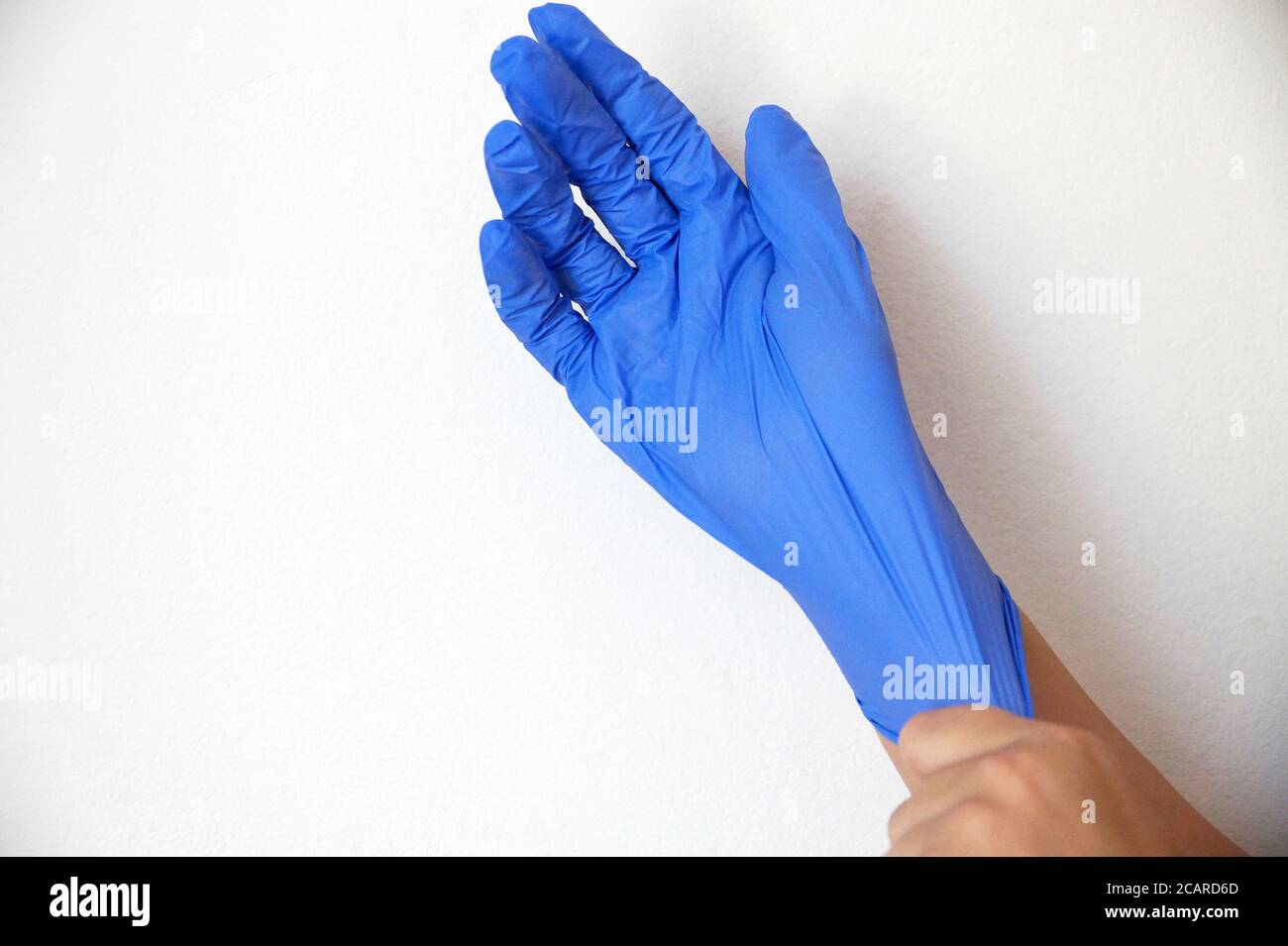 Hospital technician putting on gloves hi-res stock photography and ...