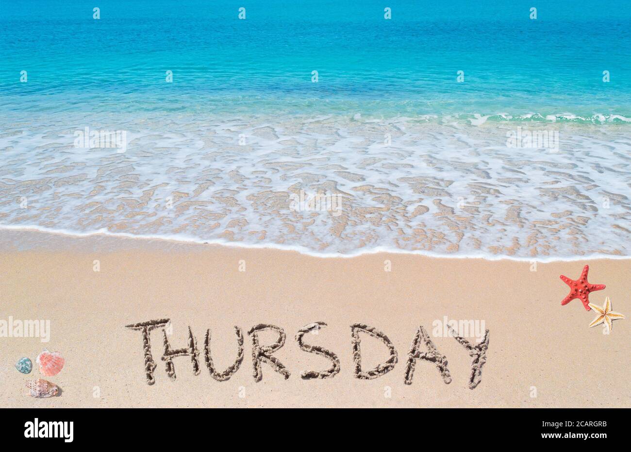 thursday written on a tropical beach Stock Photo - Alamy