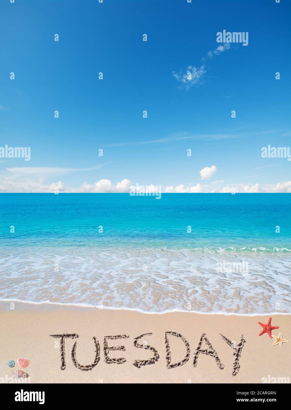 tuesday written on a tropical beach under clouds Stock Photo - Alamy