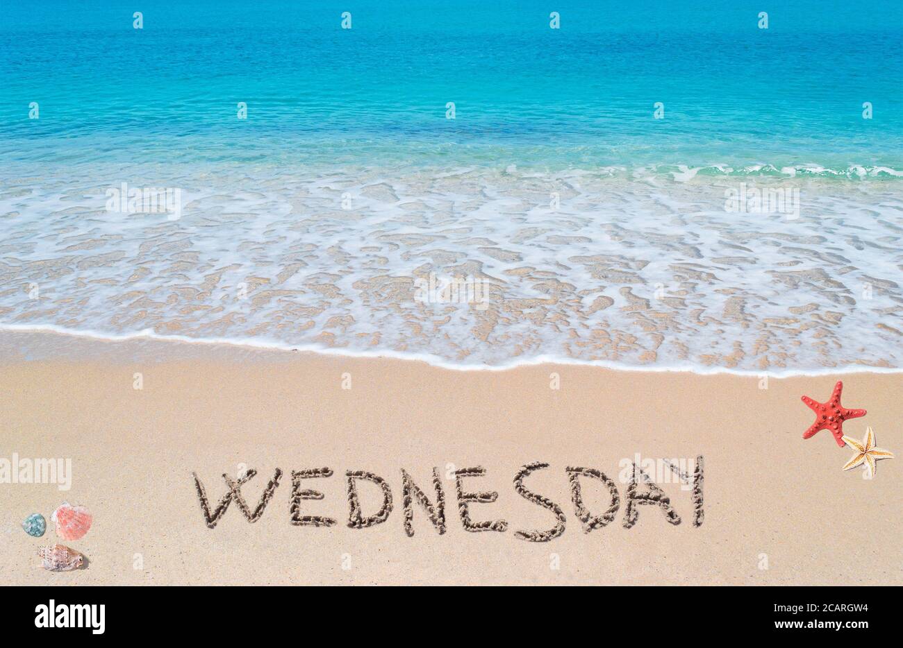 wednesday written on a tropical beach Stock Photo - Alamy