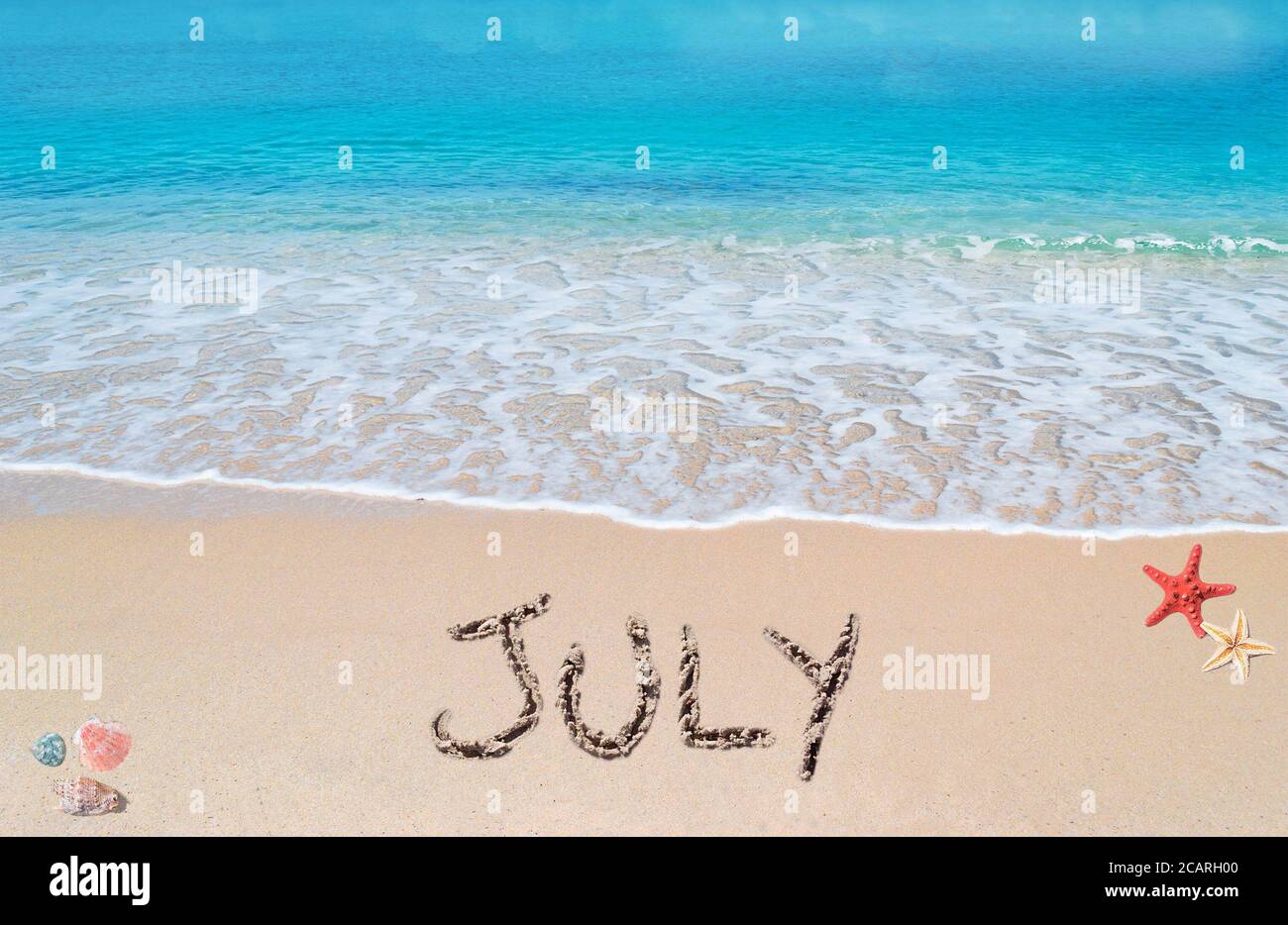 july written on a tropical beach Stock Photo - Alamy