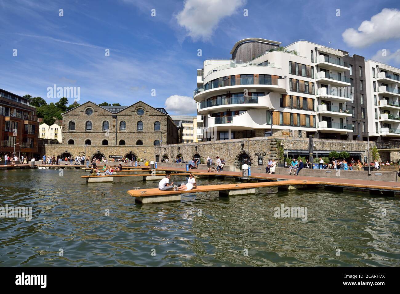 Marina in Bristol harbour with people enjoying sun sitting on Porto ...
