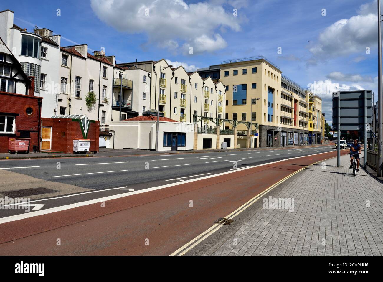 Wide quiet road with wide bus and cycle path with cyclist ridding on ...