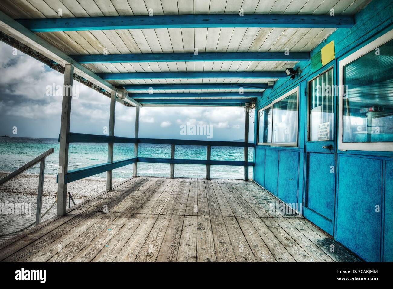 wooden terrace by the shore in Sardinia, Italy. Processed for hdr tone ...
