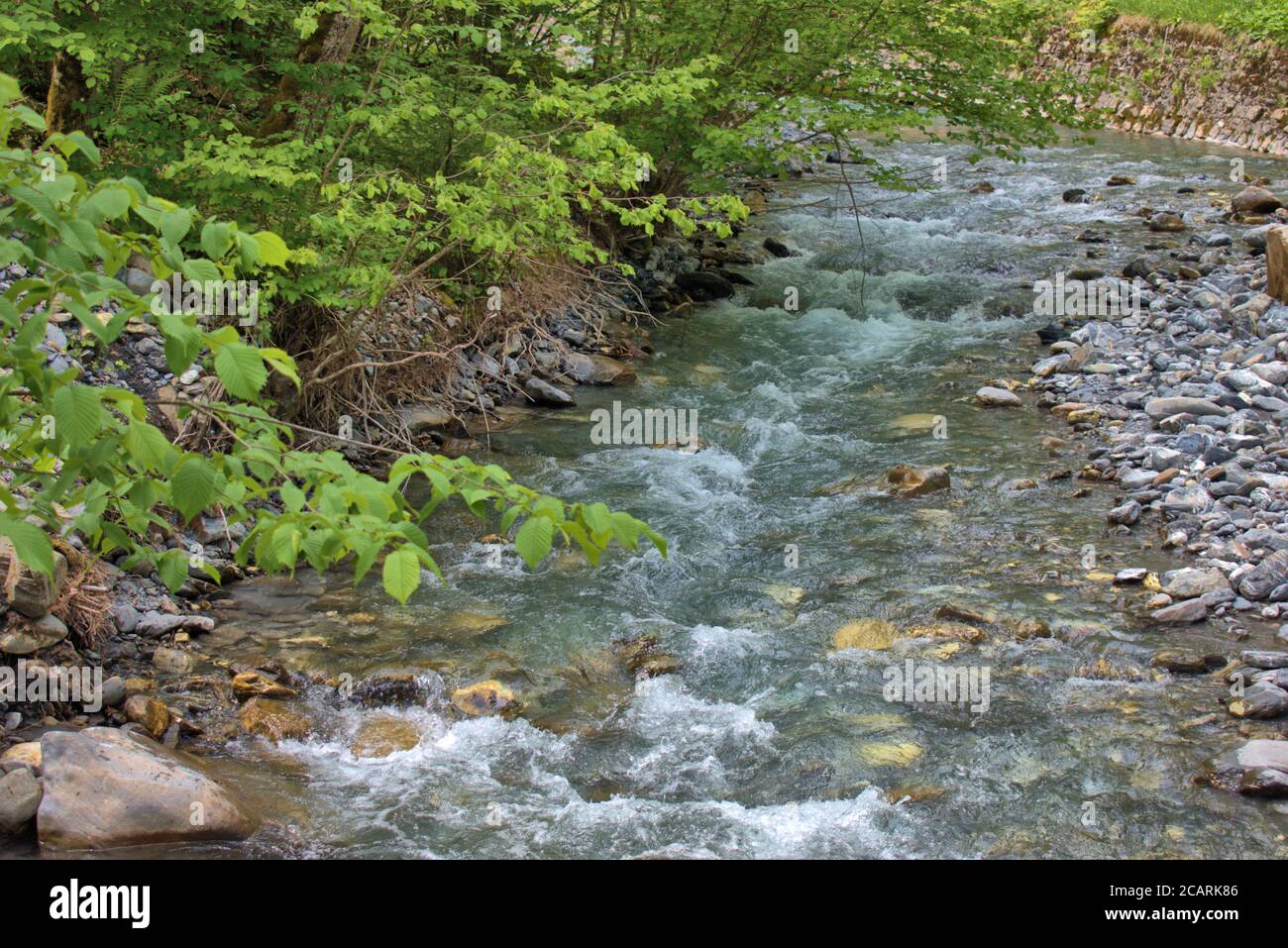 Small alpine river in Switzerland Stock Photo - Alamy
