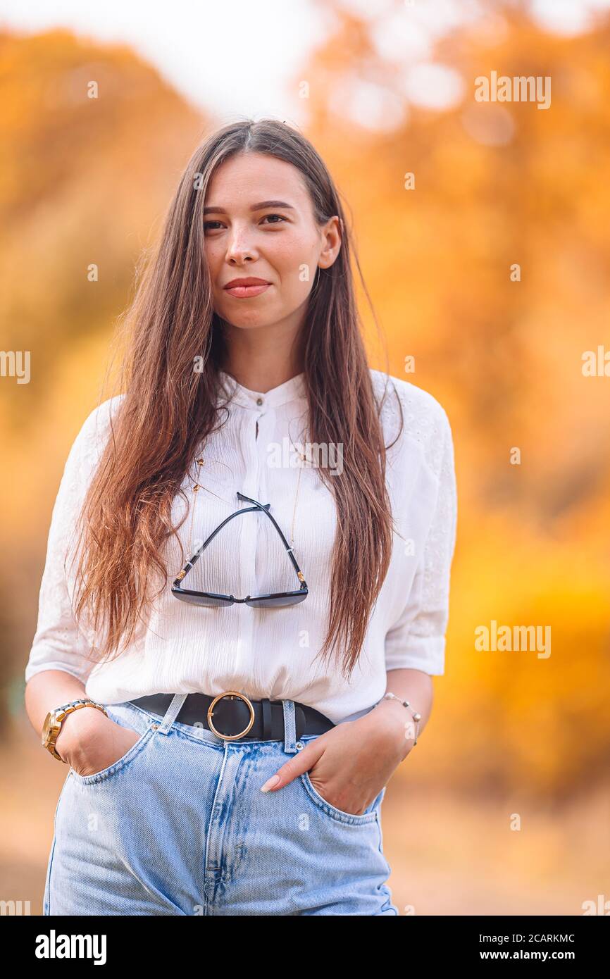 Fall concept - beautiful woman in autumn park under fall foliage Stock ...