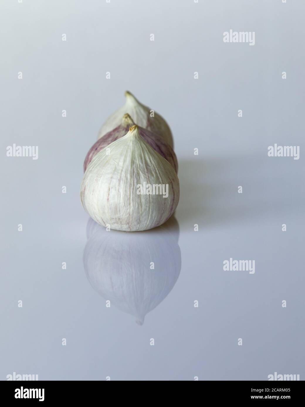 Fresh Solo garlic bulbs which are used for cooking on a white ...