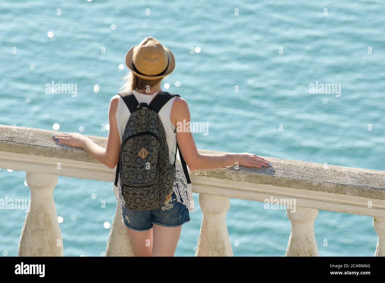 Girl looking out from balcony hi-res stock photography and images - Alamy