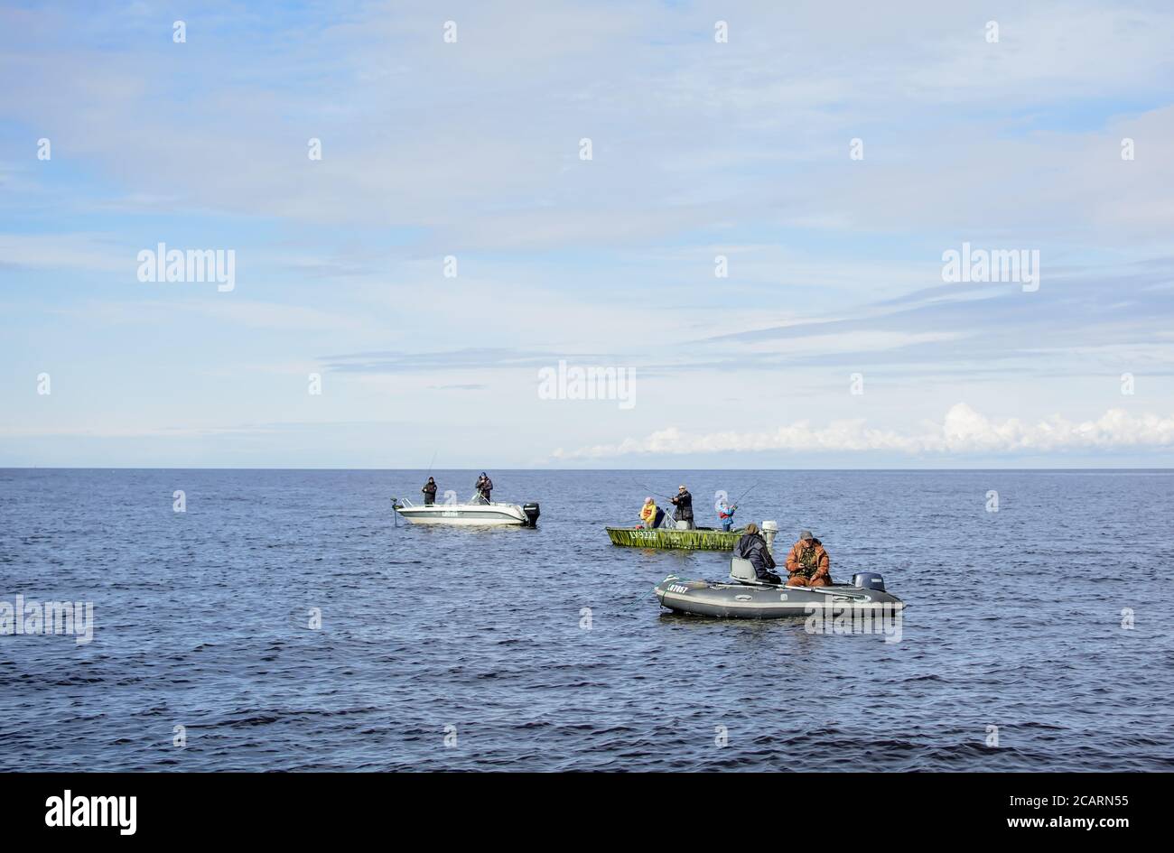 Three fishing boats with fishermen catching fish in Baltic sea Stock ...