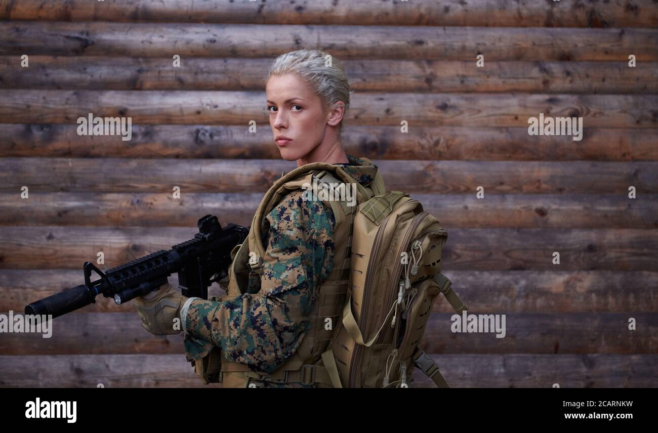 woman soldier ready for battle wearing protective military gear and ...