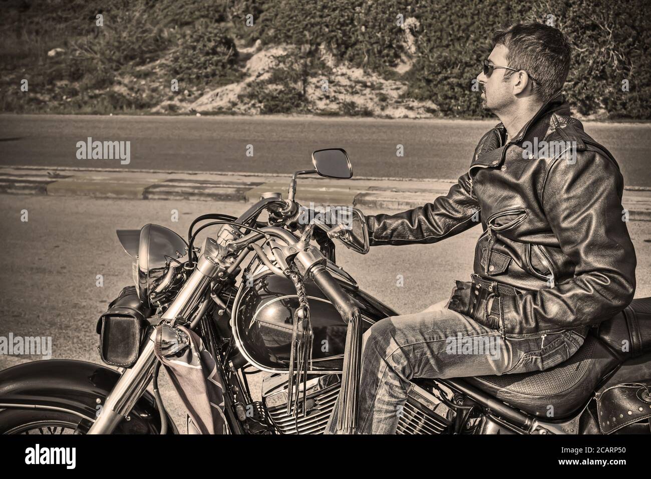 biker on a classic motorcycle in sepia tone effect Stock Photo - Alamy