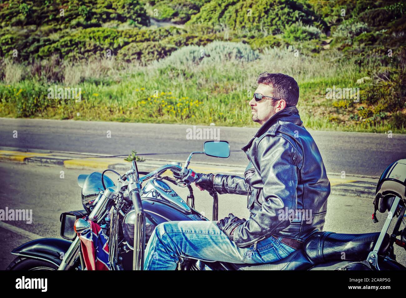 side view of a biker on a classic motorcycle in hdr Stock Photo - Alamy