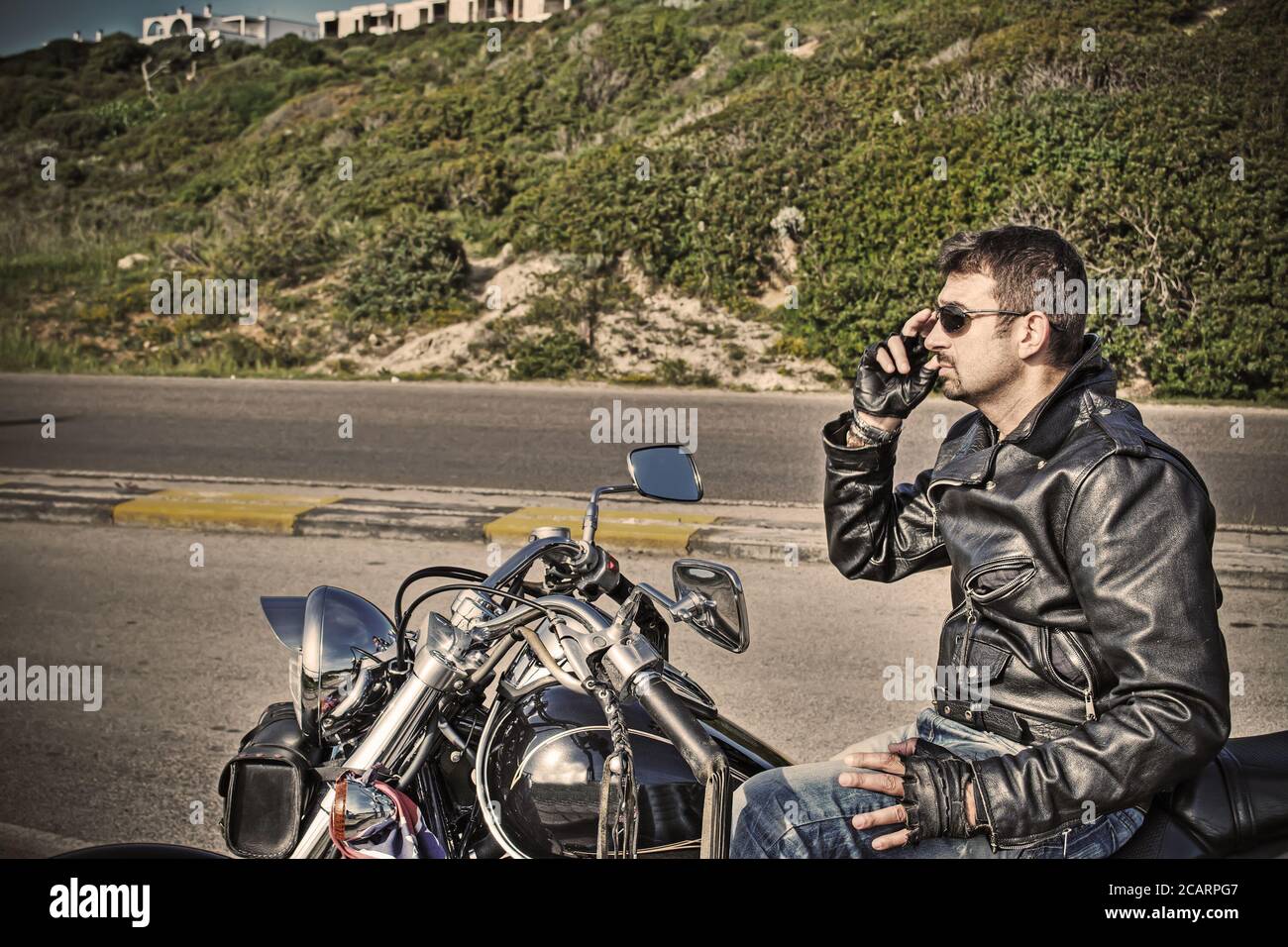 biker on a classic motorcycle in sepia tone effect Stock Photo - Alamy