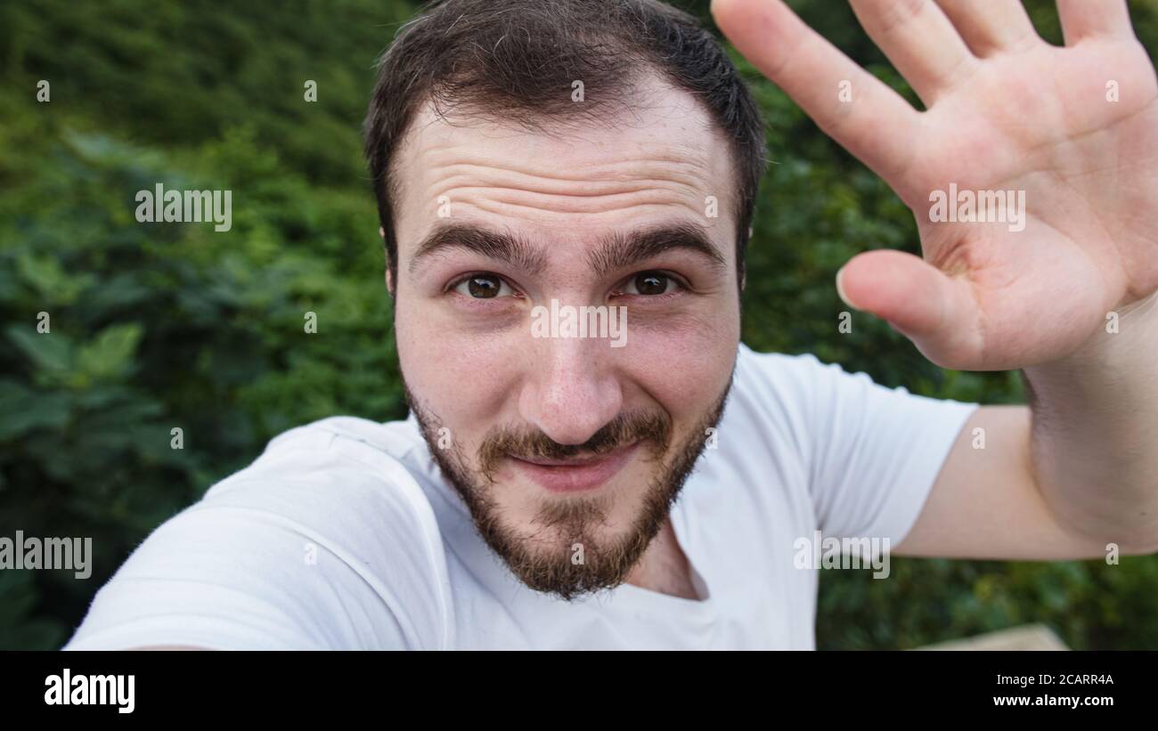 White skin man talking video on phone in nature close-up Life style ...