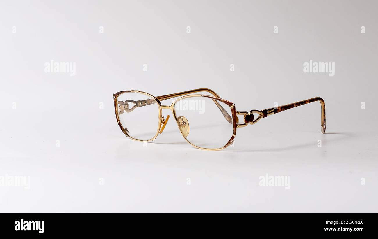 Gold-rimmed glasses. Close-up, isolate on a white background Stock ...