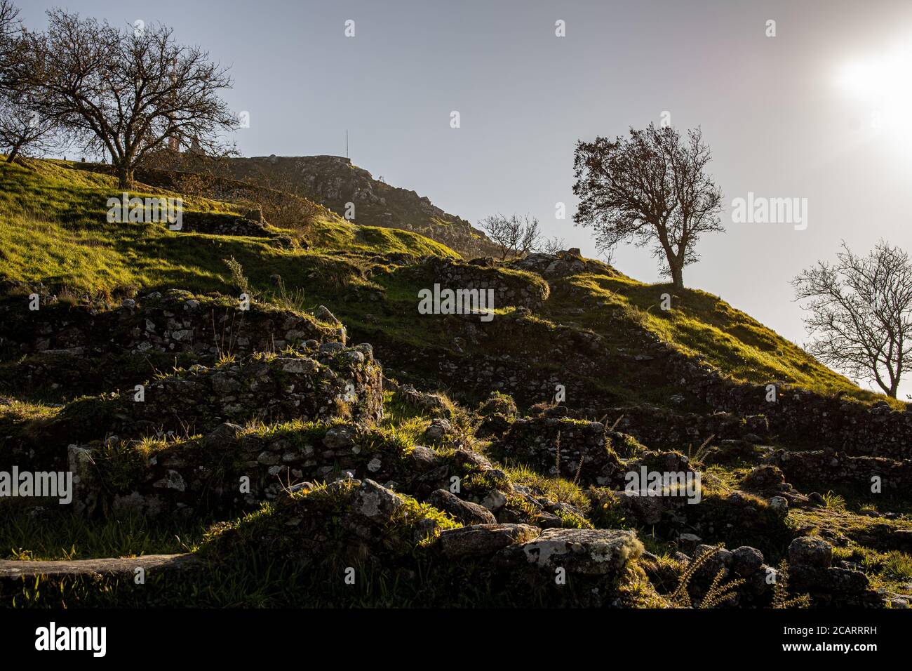 Beautiful shot of a hill covered with green grasses on a thin cloud ...
