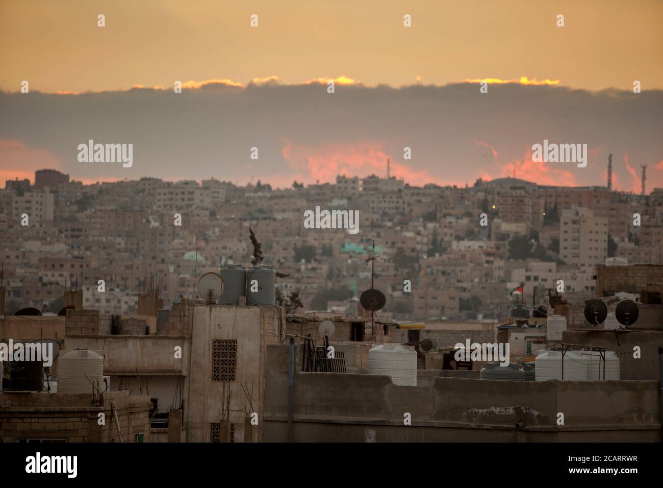 Rooftop water storage tanks are a common site in the arid city of Zarqa ...
