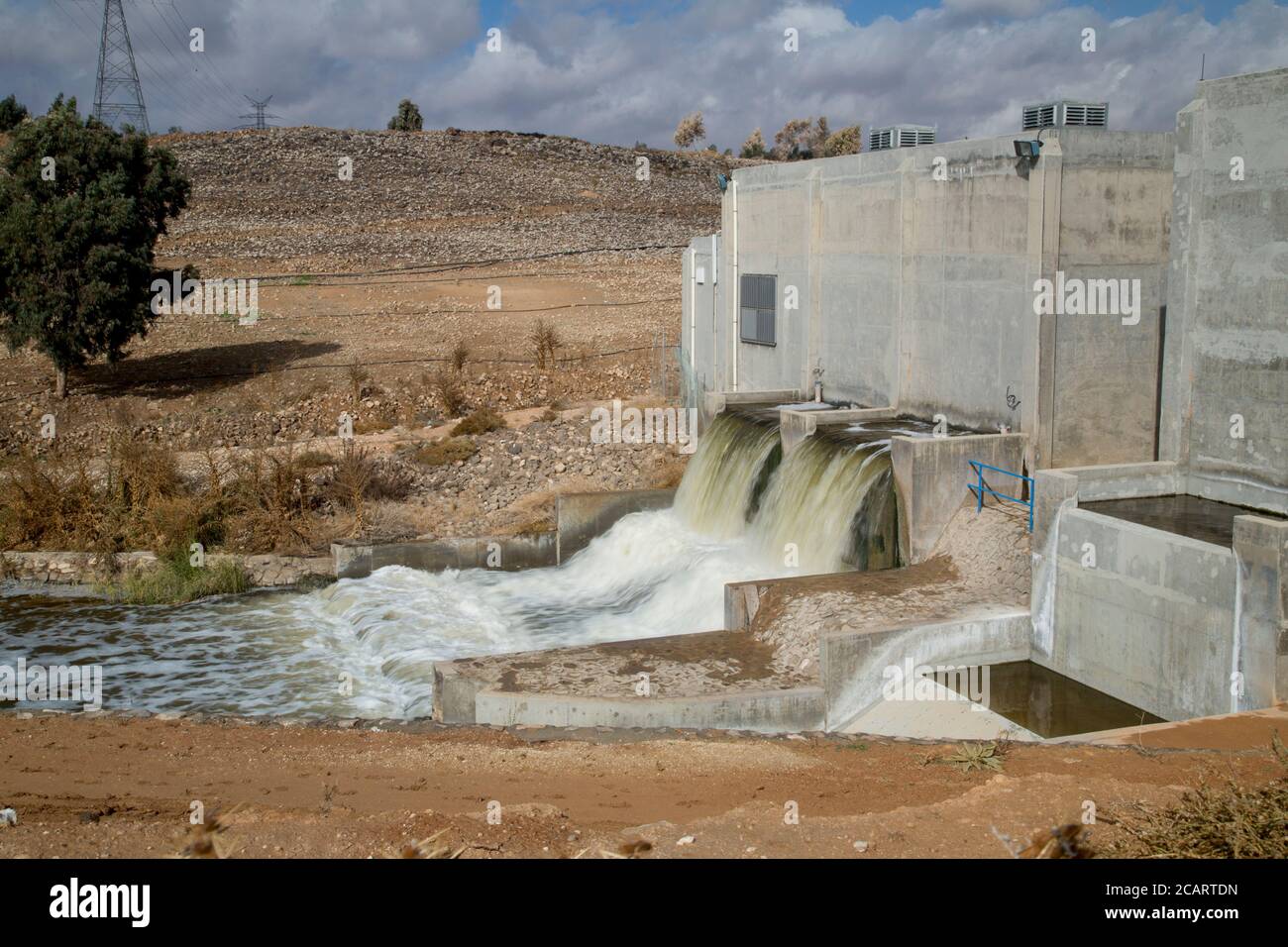 Clean, treated water flows from the As-Samra wastewater treatment plant ...
