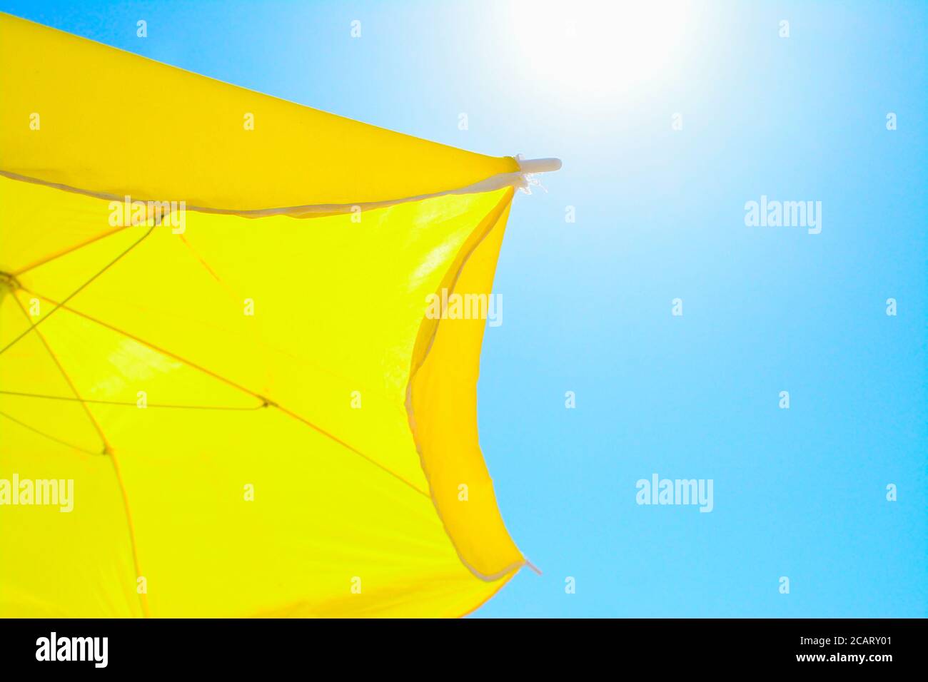 yellow parasol under a shining sun in the summertime Stock Photo - Alamy