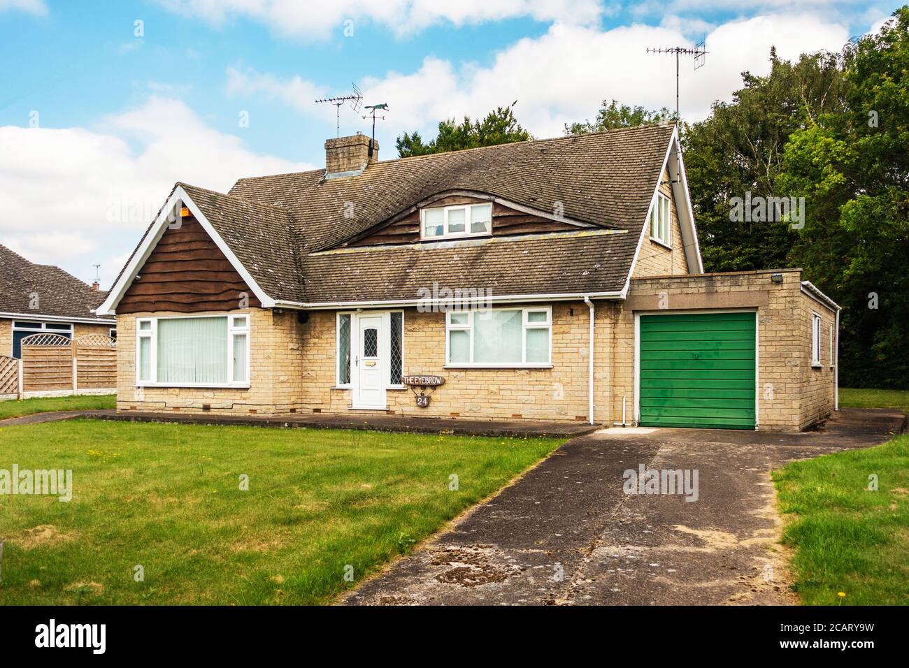 house with an eyelid shaped window in the roof Stock Photo - Alamy