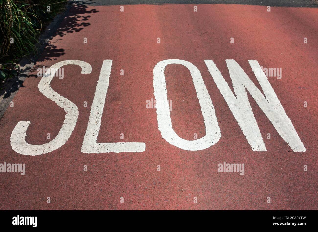 Slow road markings on hi-res stock photography and images - Alamy