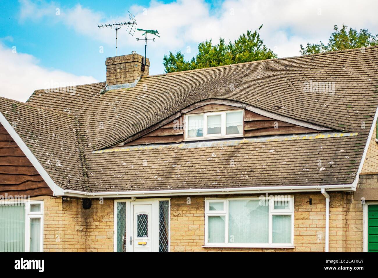 house with an eyelid shaped window in the roof Stock Photo - Alamy