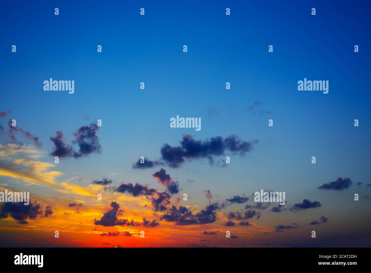 colorful sunset with dark clouds Stock Photo - Alamy