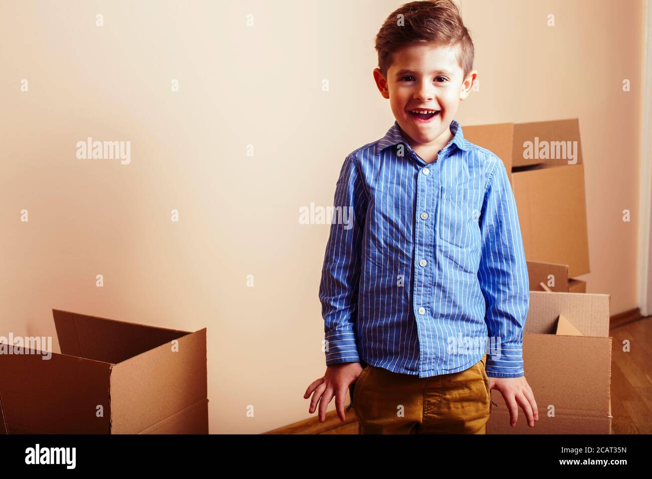 little cute boy in empty room, move to new house. home alone among ...