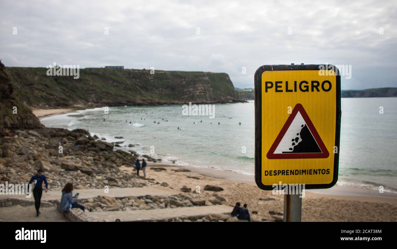 Danger sign indicating rockfall at the beach Stock Photo - Alamy