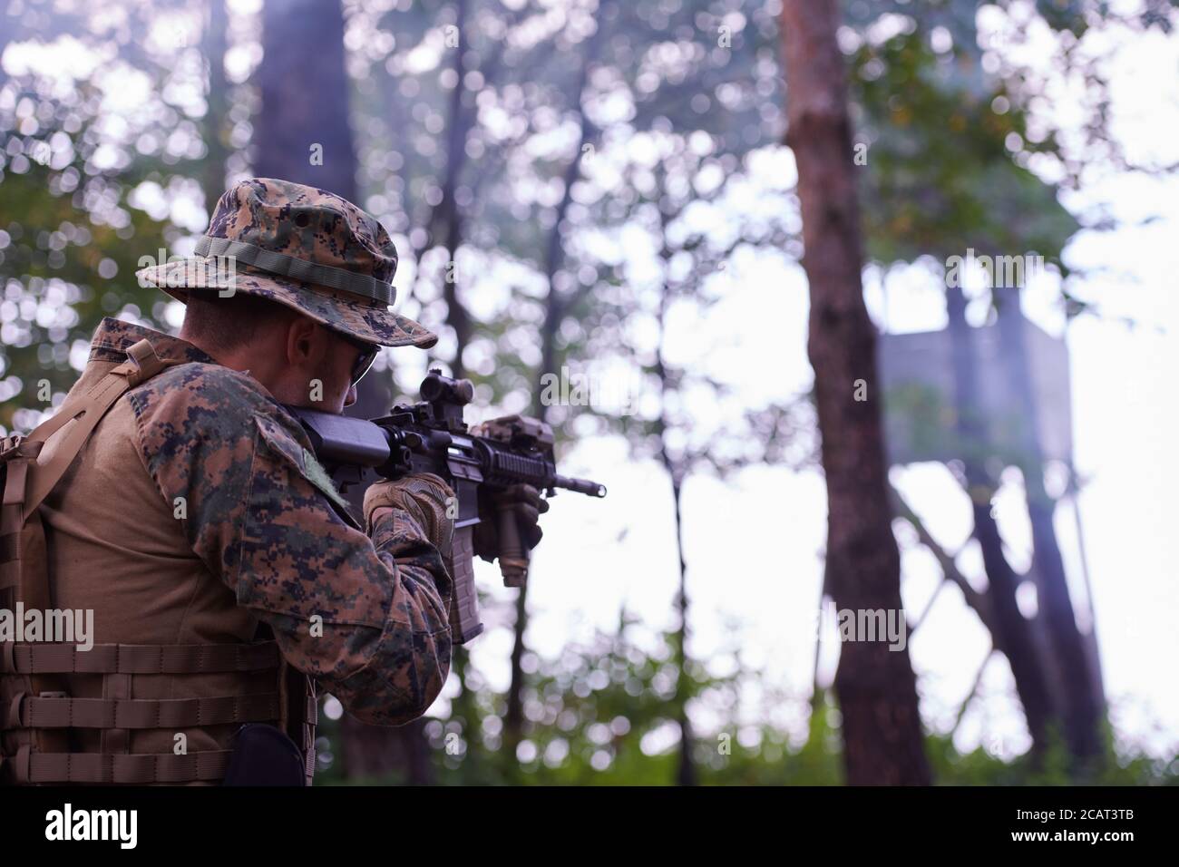 modern warfare soldier in action aiming at weapon laser sight optics in ...