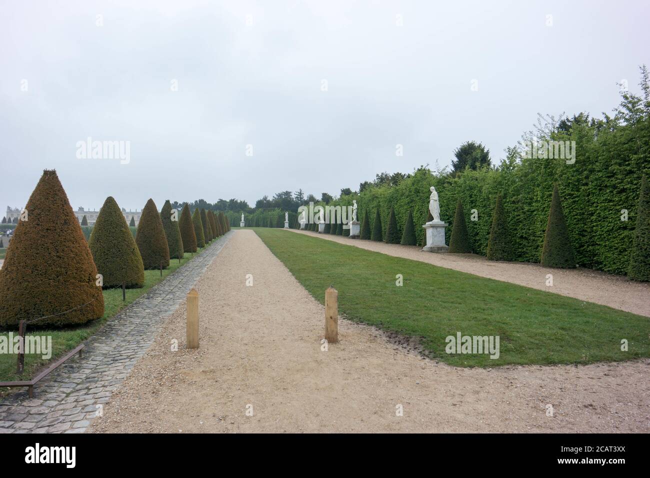 Beautiful shot of the long green alley with sculptures in the gardens ...